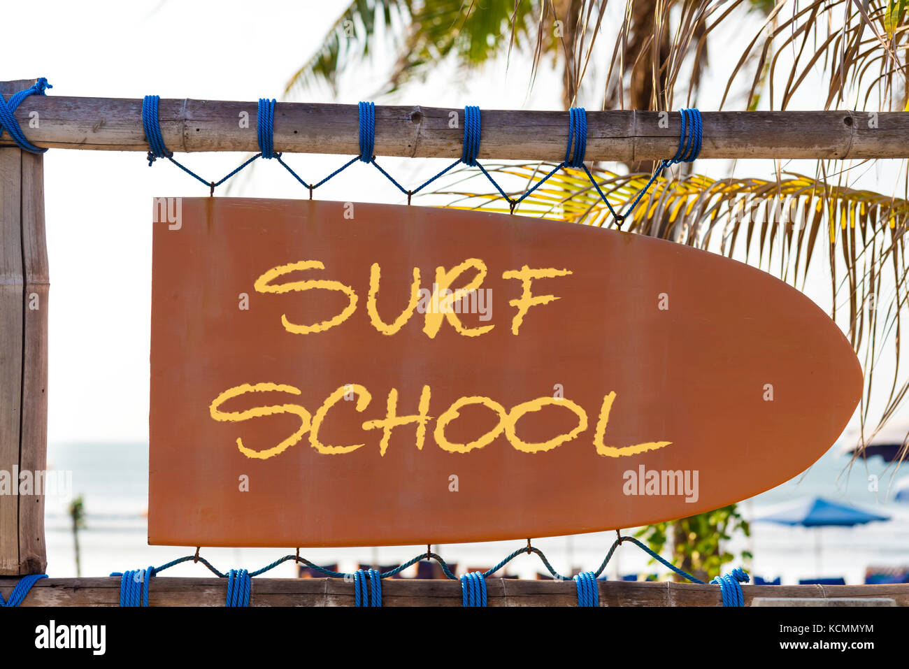 Orange vintage signboard in shape of surfboard with Surf School text ...