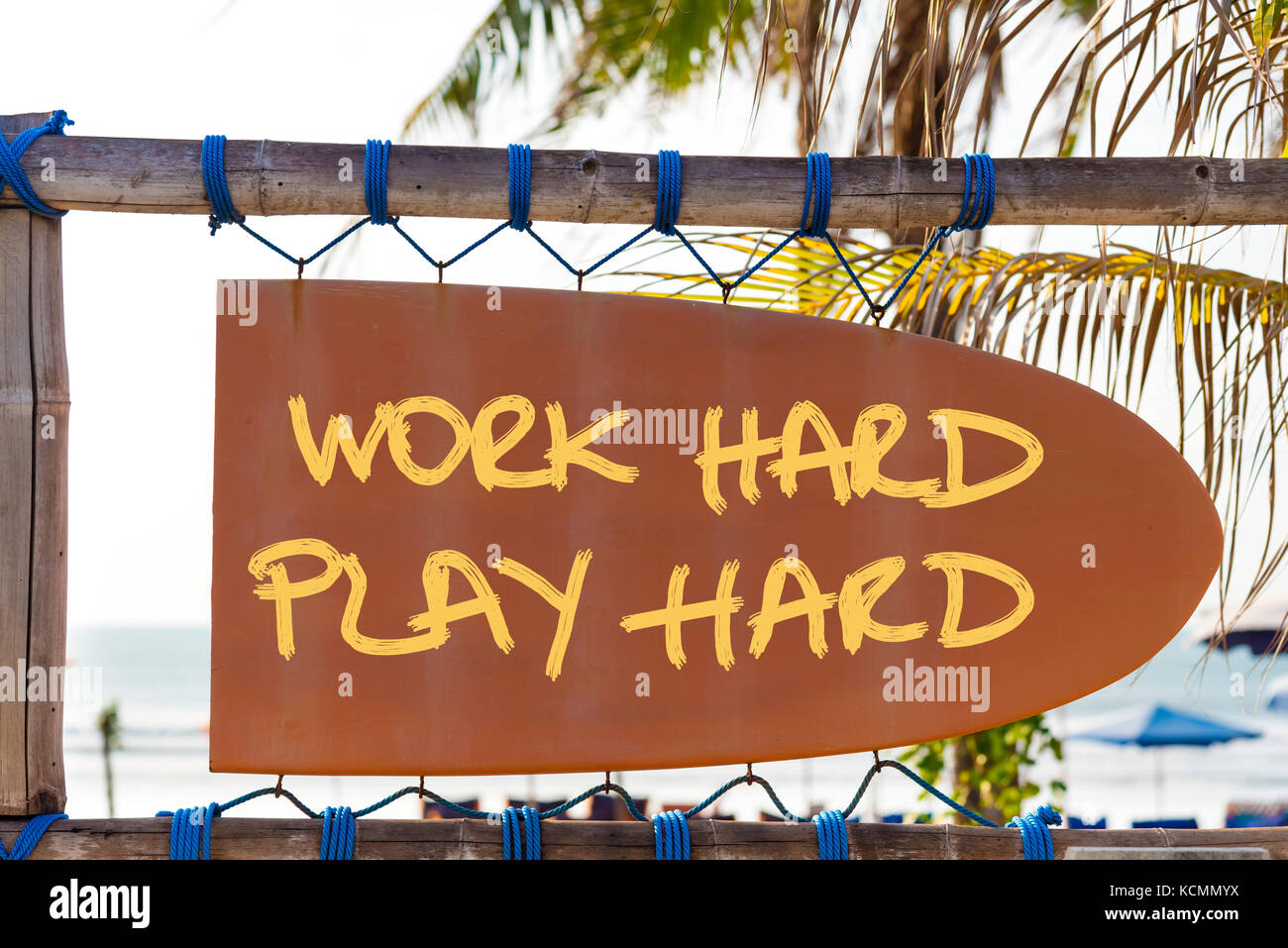 Orange vintage signboard in shape of surfboard with Work Hard Play Hard ...