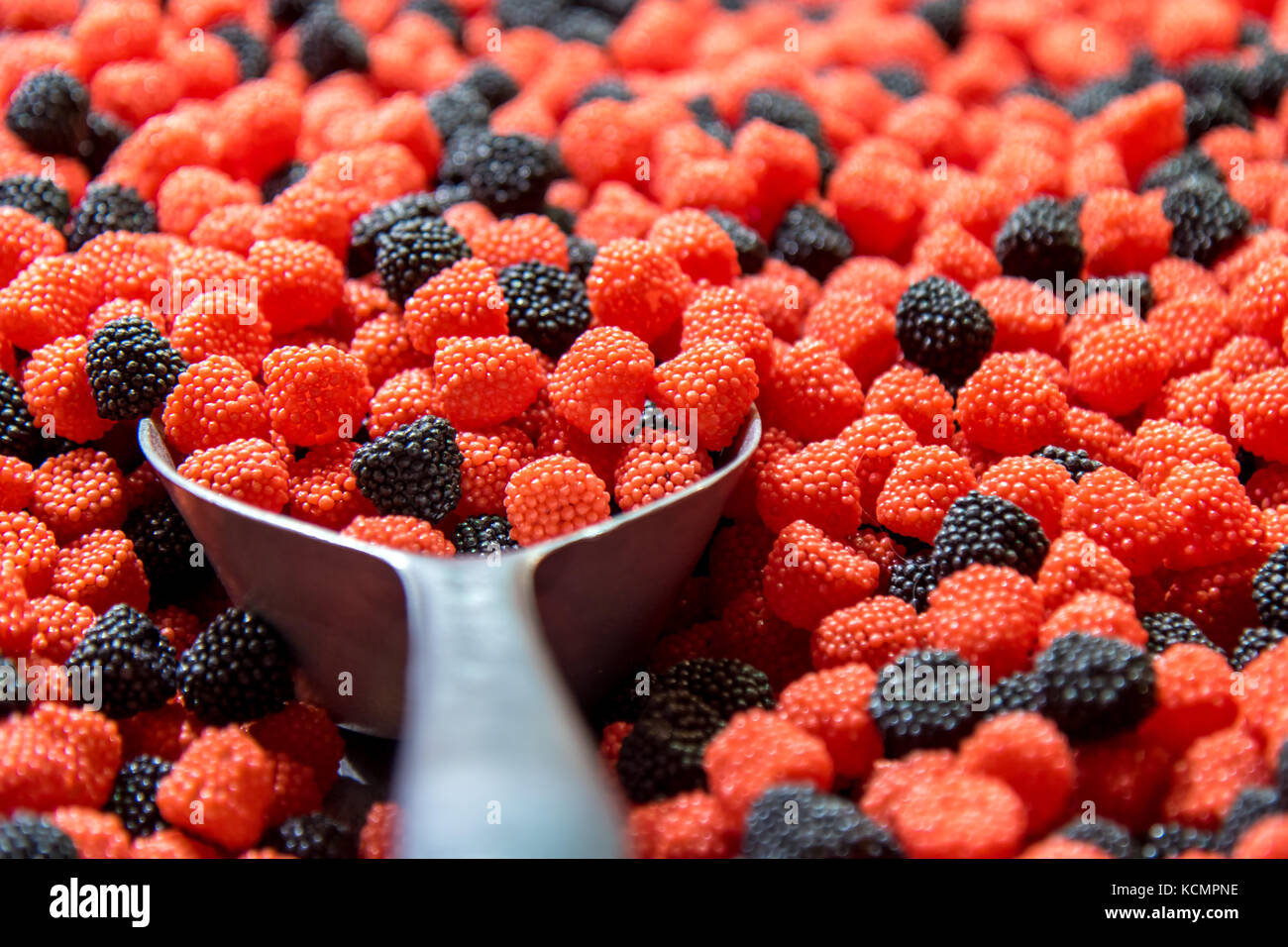 Small scoop in a heap of berry candy. Offer of sweets in the shop Stock ...