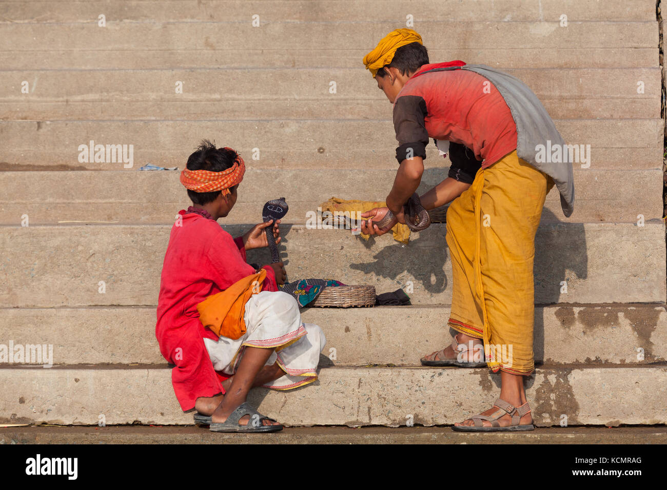 Children with cobras at ghat steps on river Ganges, Varanasi, Uttar ...