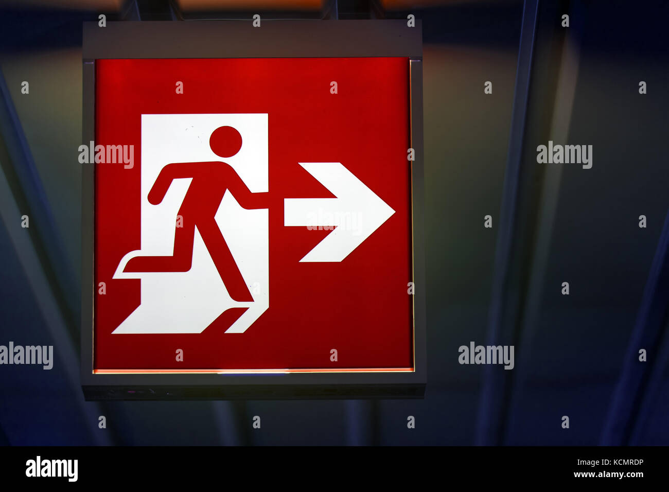 The emergency exit sign shows the direction of escape in case of danger ...