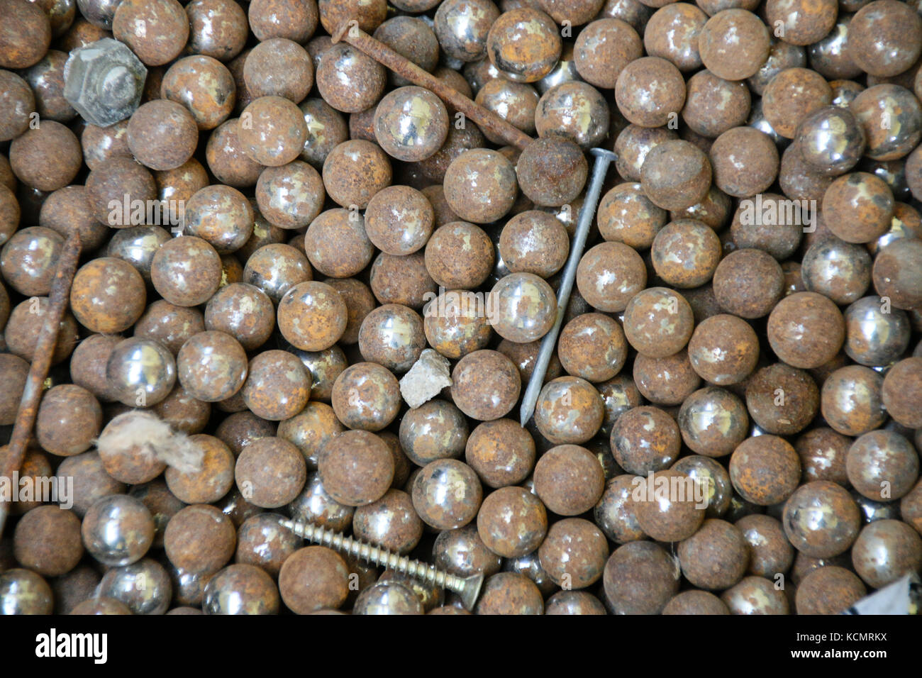Rusty iron balls and nails Stock Photo - Alamy
