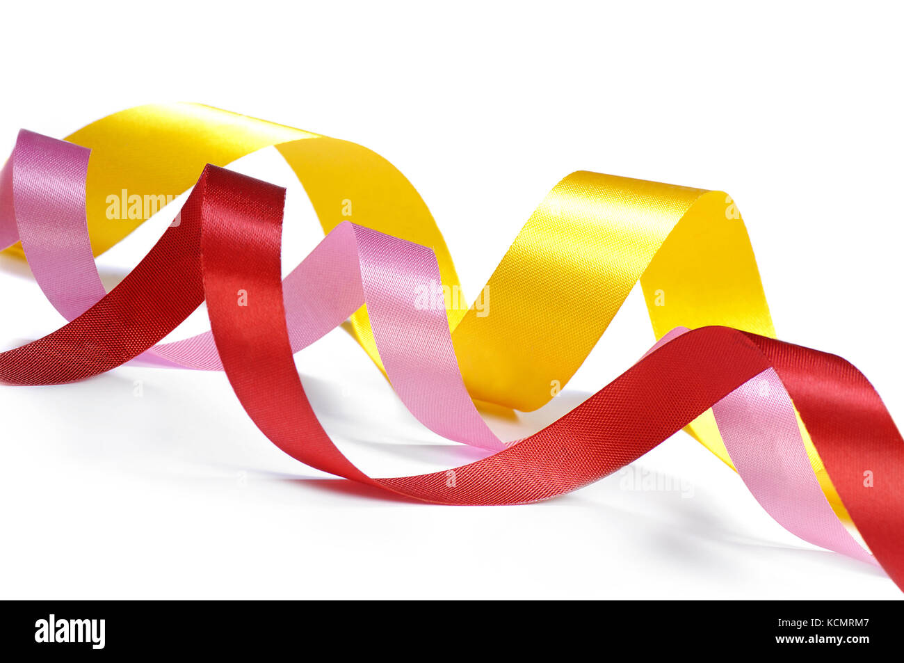 Three curled ribbons in pink, red, and yellow color Stock Photo - Alamy