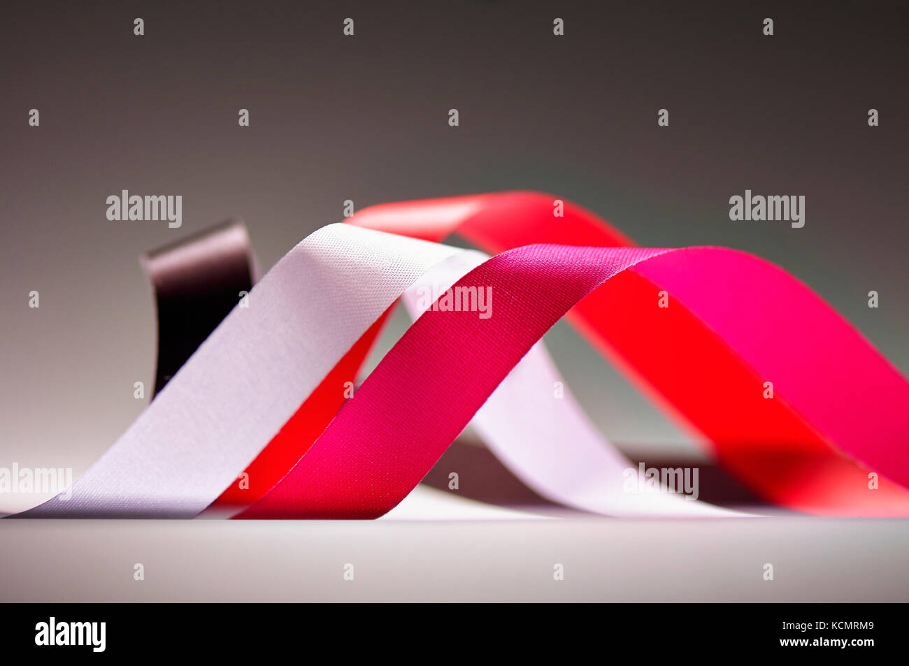 Four curled ribbons in pink, red, brown and white color Stock Photo - Alamy
