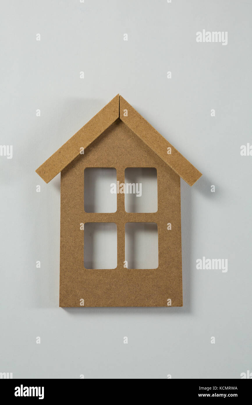 Wooden house shape decoration on white table Stock Photo - Alamy