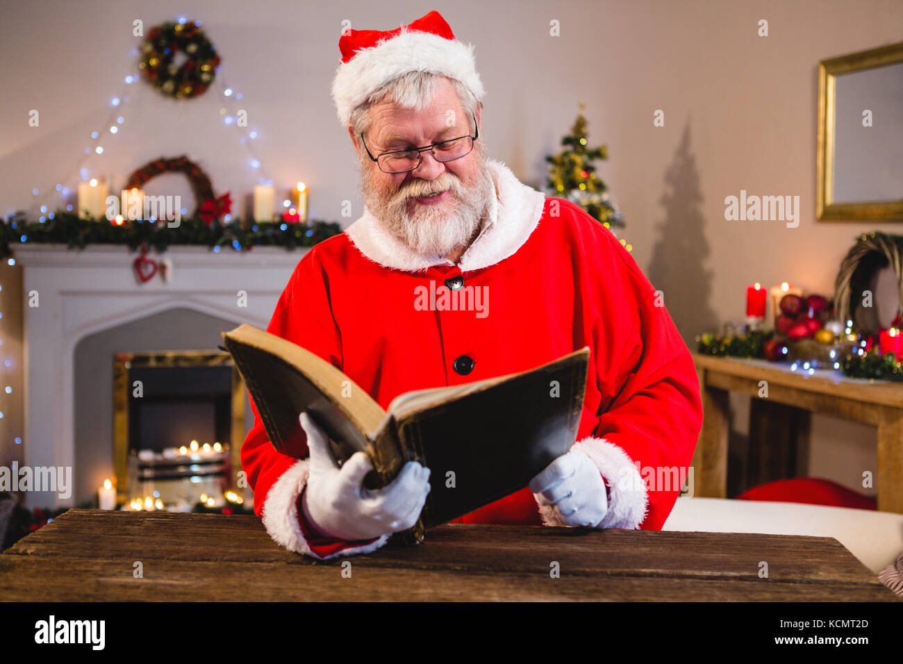 Santa Claus reading book at home Stock Photo - Alamy