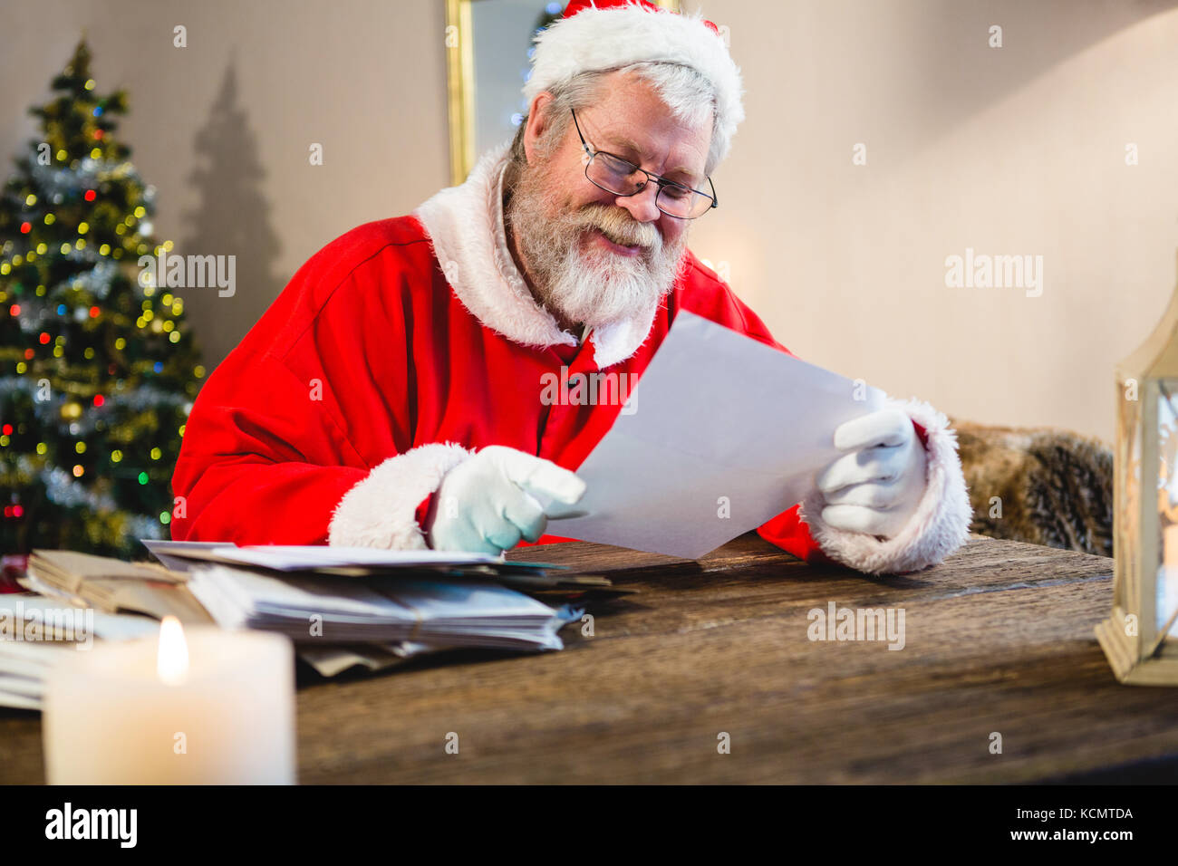 Santa Claus reading a letter at home Stock Photo - Alamy