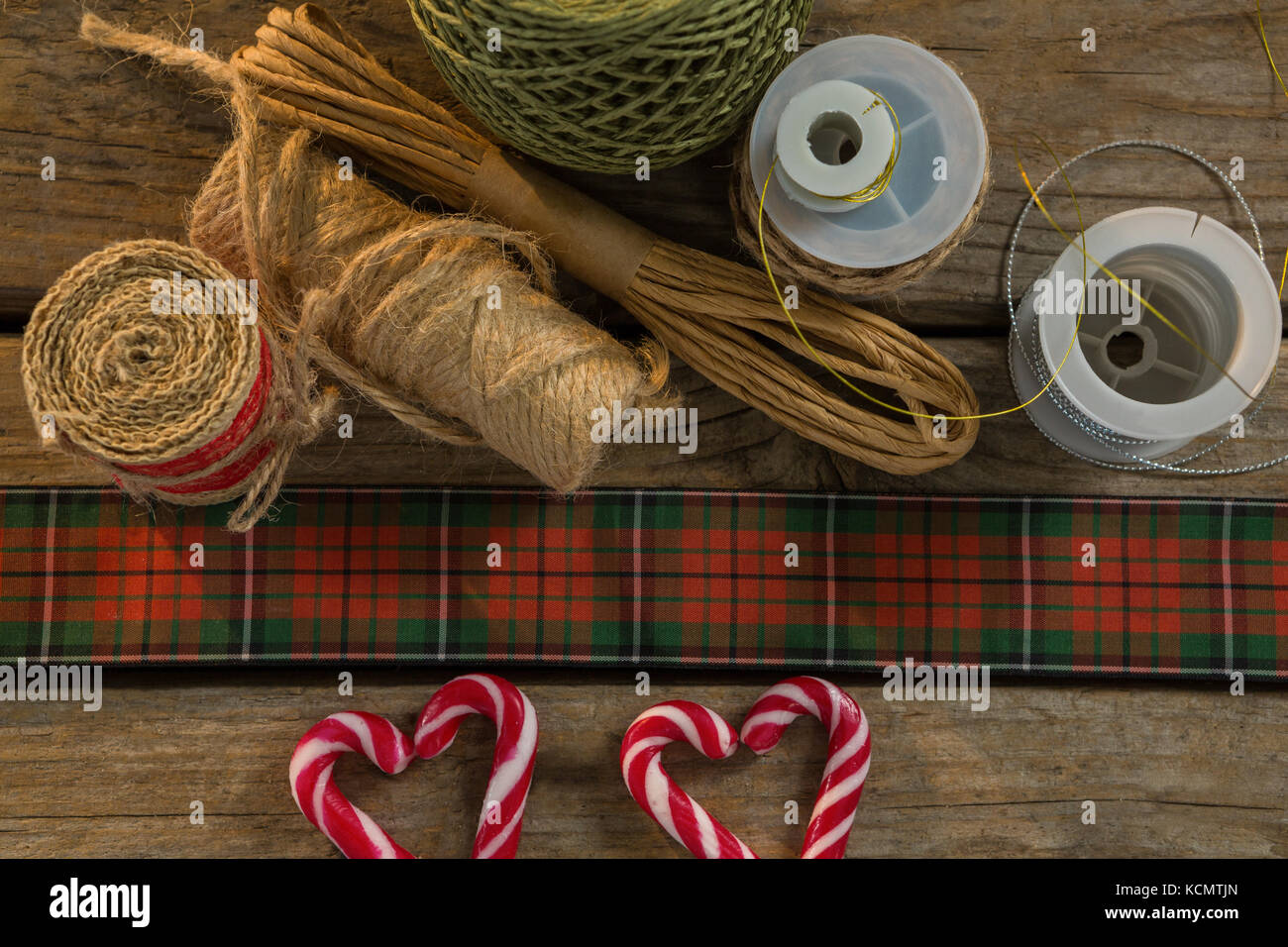 Overhead view of thread spools with candy cane on table Stock Photo - Alamy