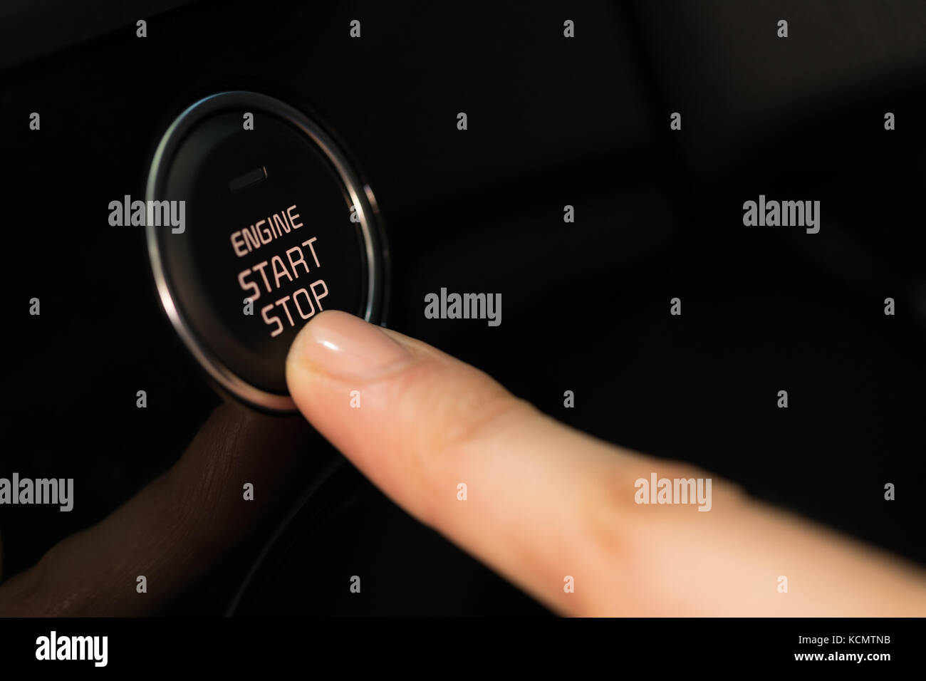 Cropped finger pressing start button in car while test driving Stock ...