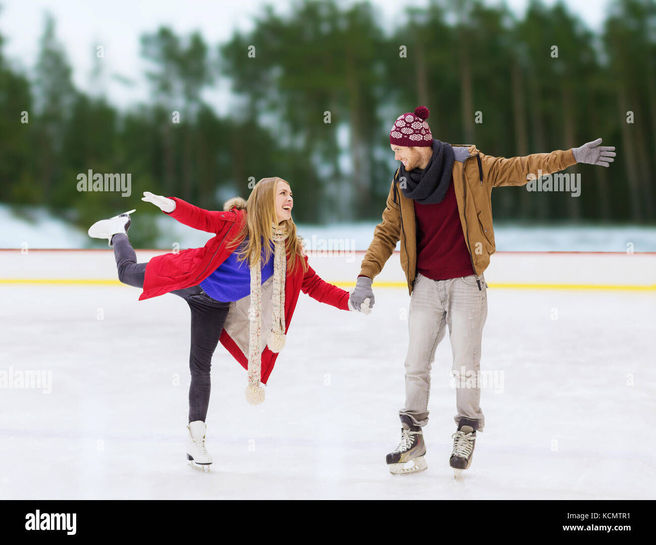 happy couple holding hands on skating rink Stock Photo - Alamy