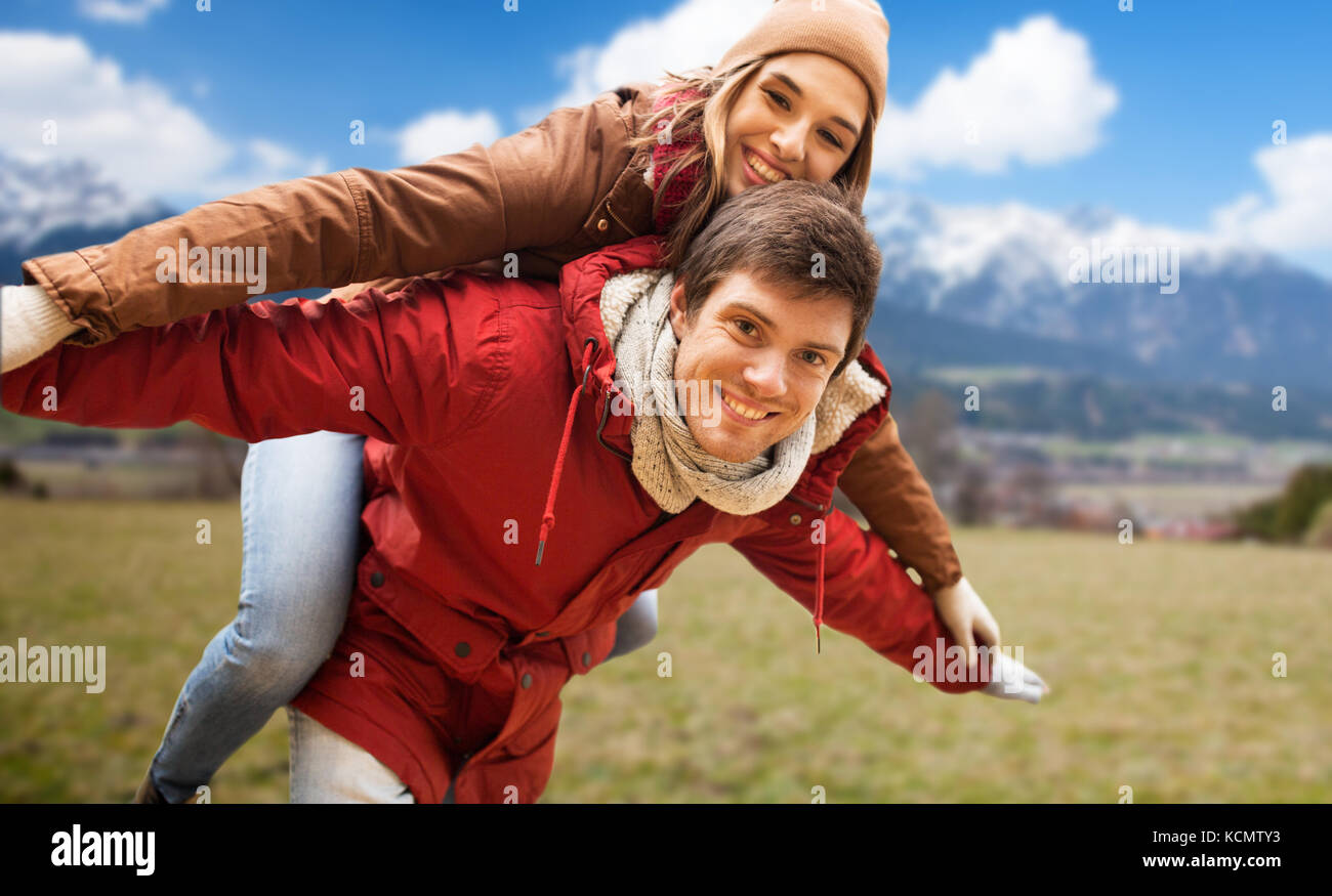 happy young couple having fun over alps mountains Stock Photo - Alamy