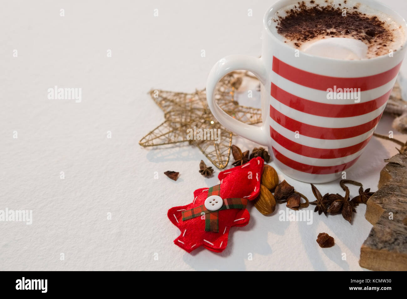Coffee with cinnamon powder and christmas decorations on white ...