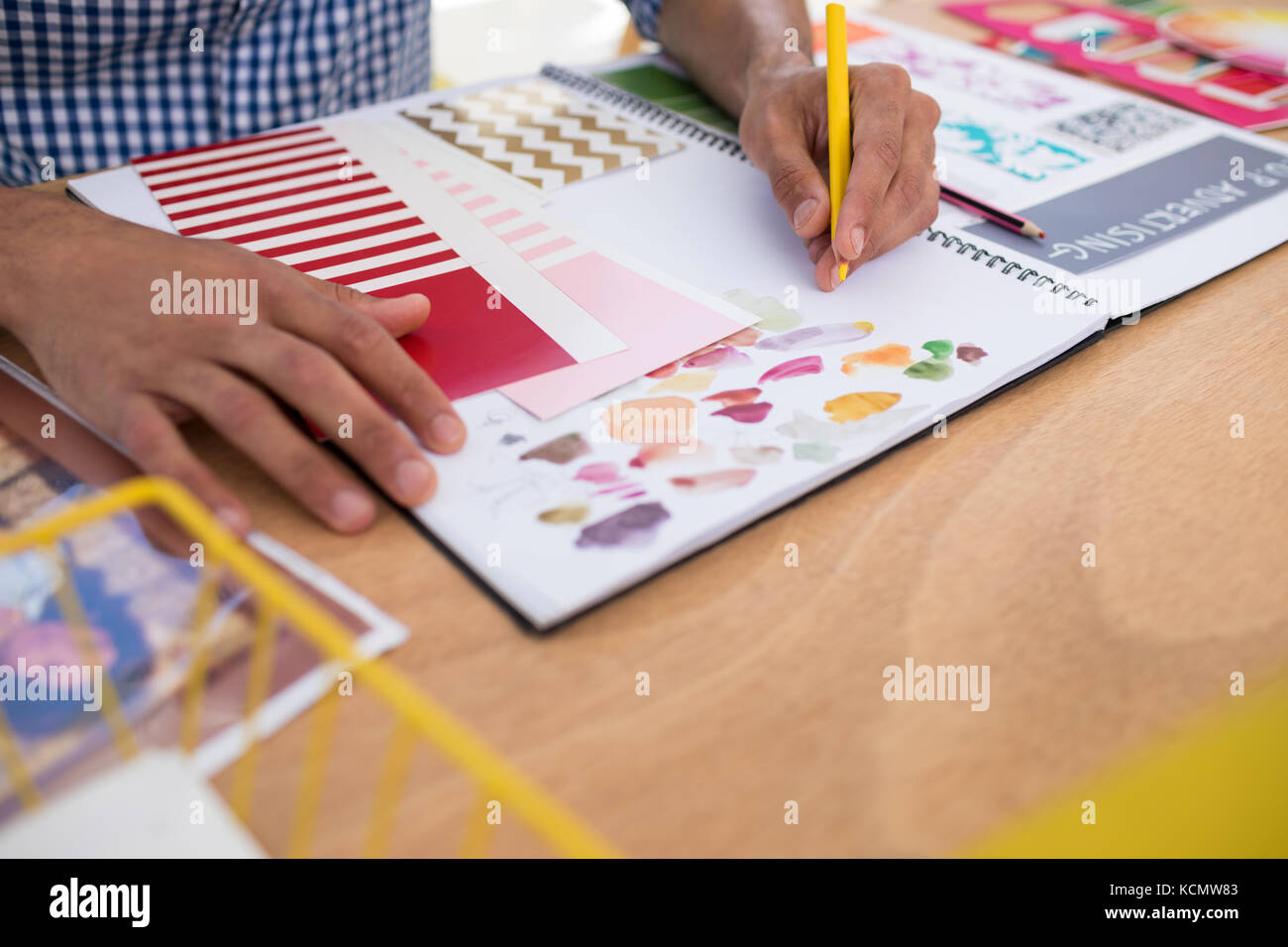 Male graphic designer working at desk Stock Photo - Alamy