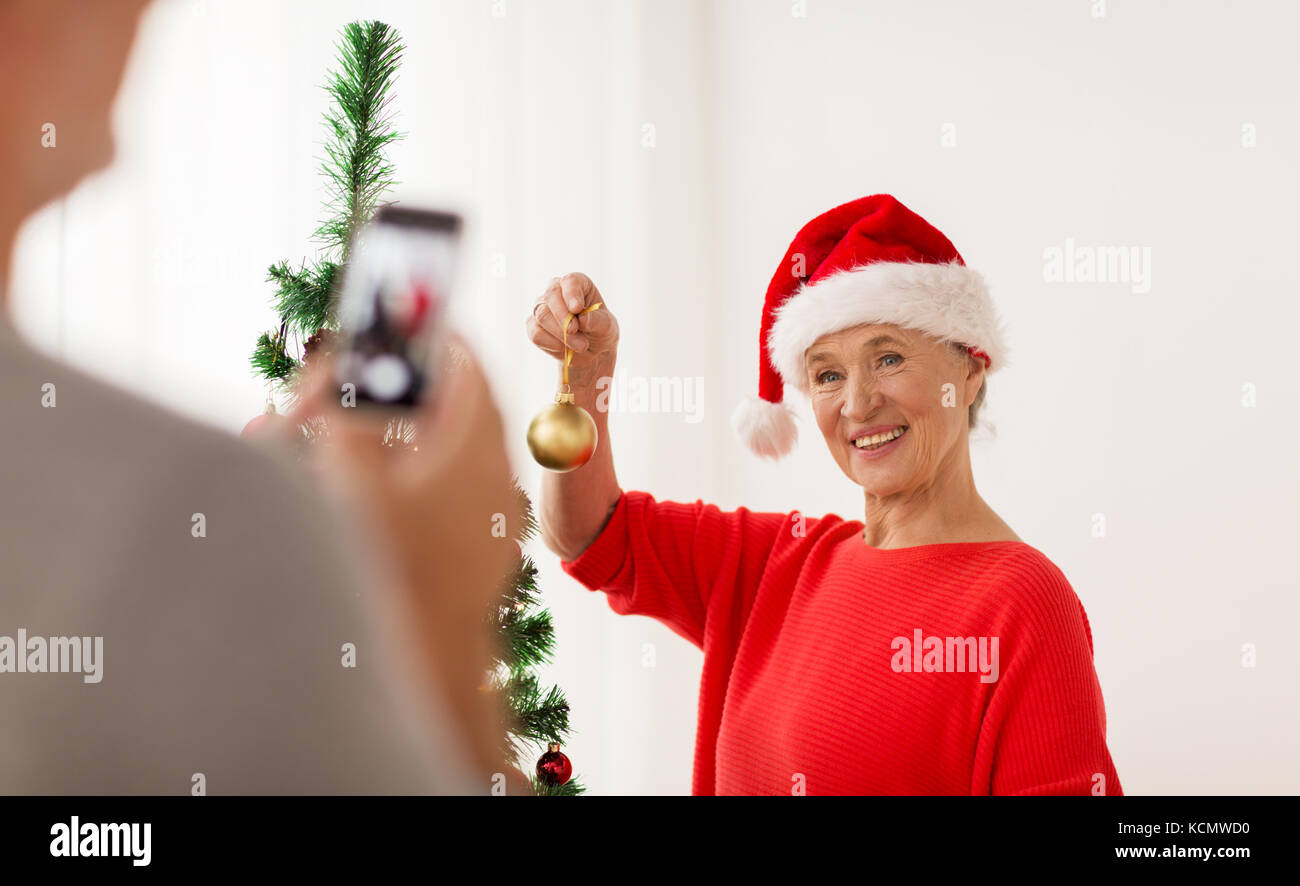 happy senior woman decorating christmas tree Stock Photo - Alamy happy senior woman decorating christmas tree Stock Photo - Alamy