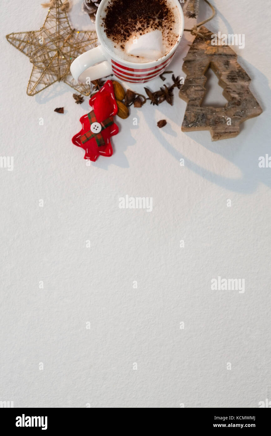 Coffee with cinnamon powder and christmas decorations on white ...