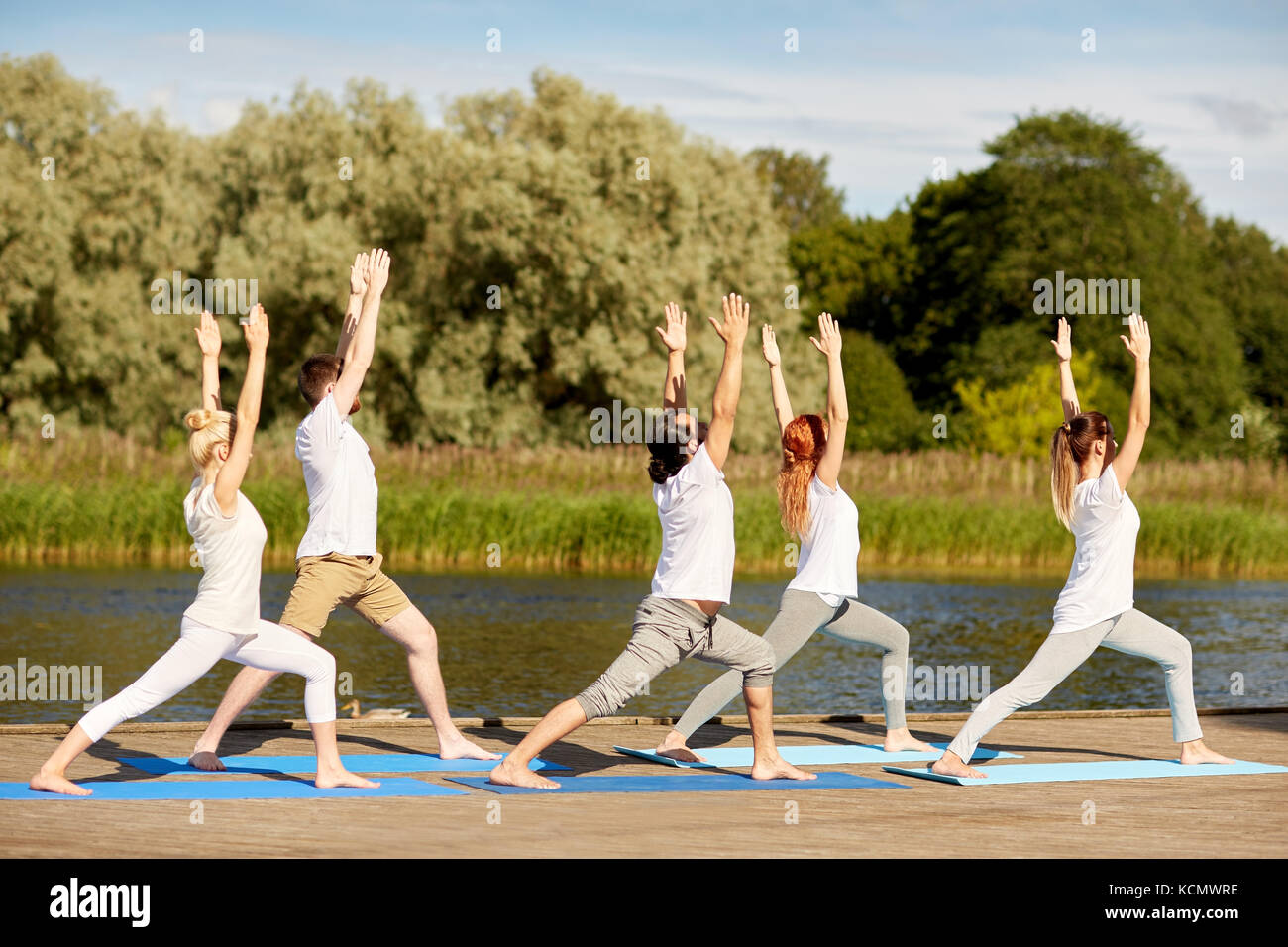 group of people making yoga exercises outdoors Stock Photo - Alamy