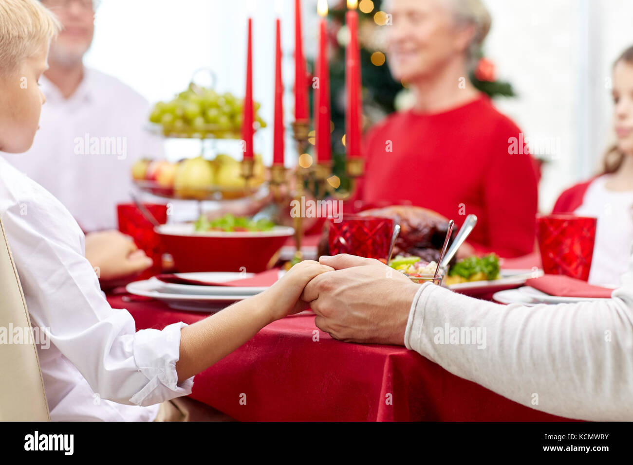family having holiday dinner and praying at home Stock Photo - Alamy