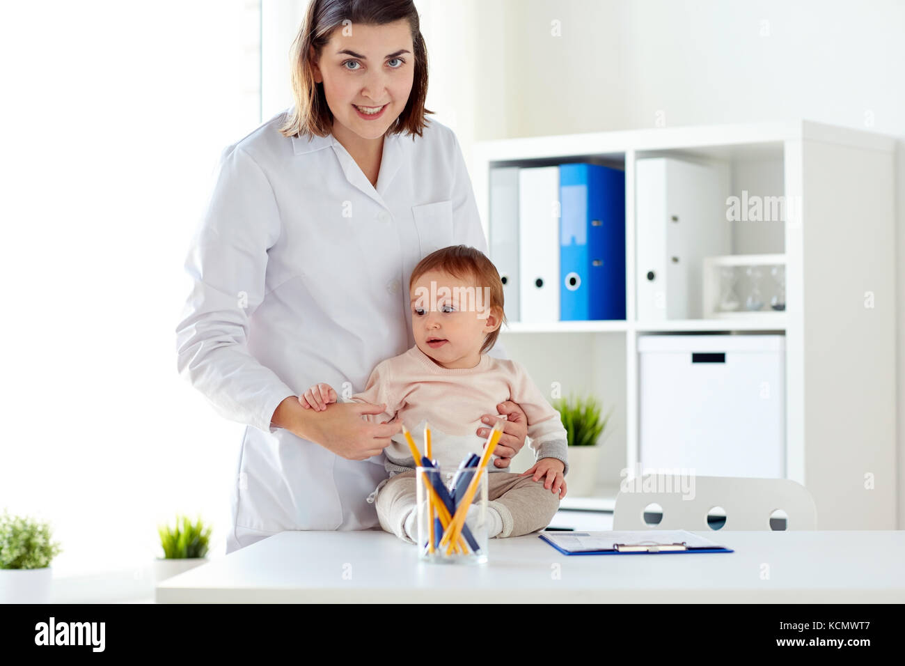 happy doctor or pediatrician with baby at clinic Stock Photo - Alamy