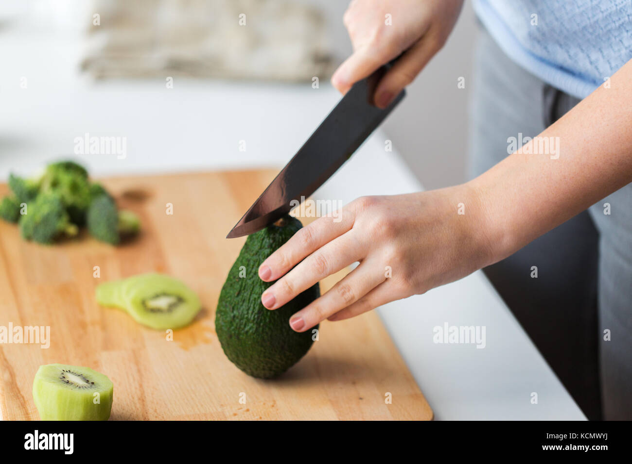 woman hands chopping avocado on cutting board Stock Photo - Alamy