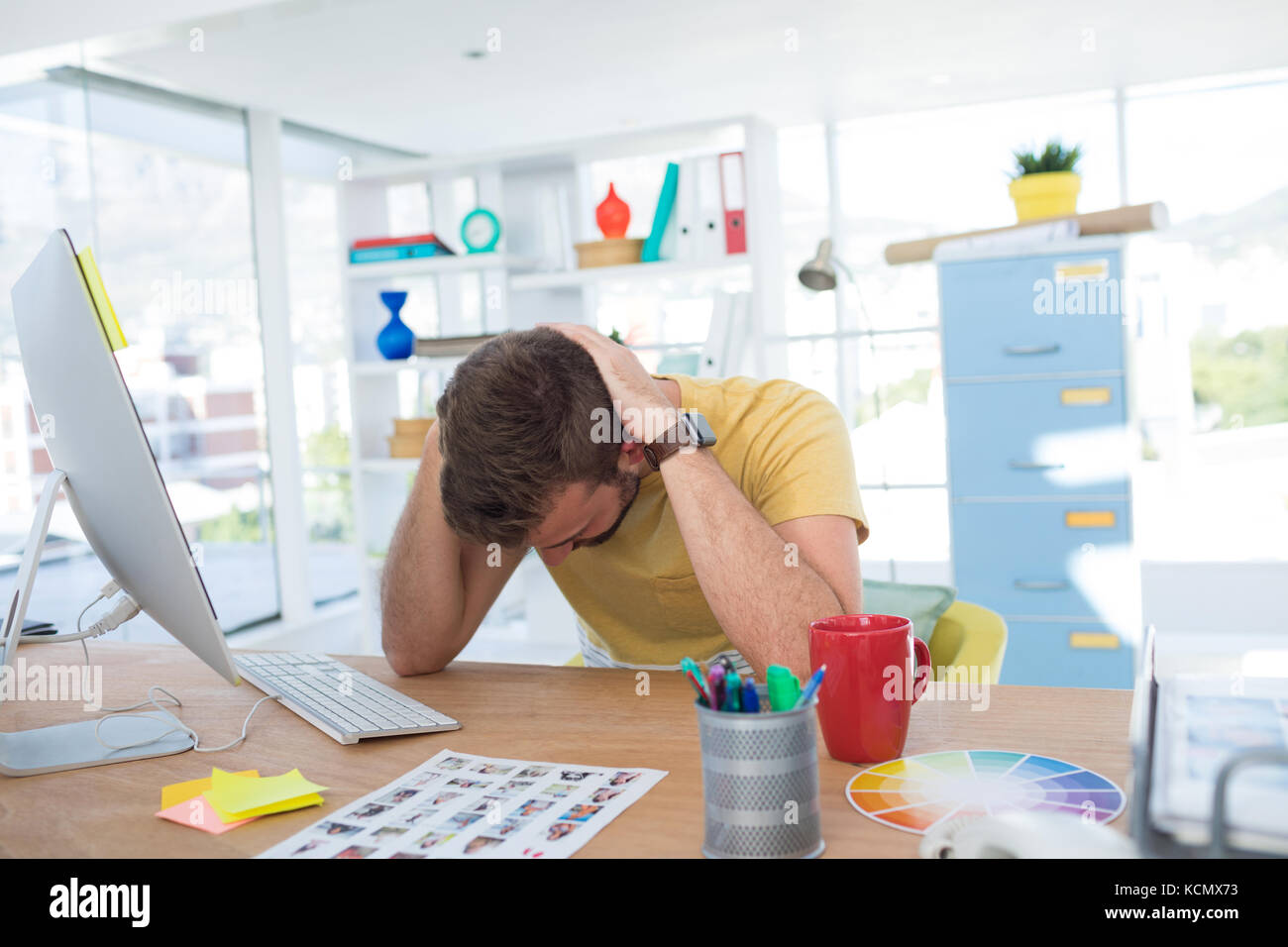 Depressed male executive working on computer in the office Stock Photo ...