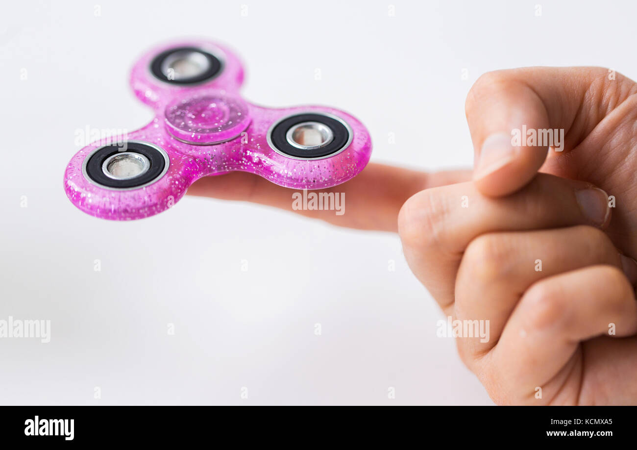 close up of hand playing with fidget spinner Stock Photo - Alamy