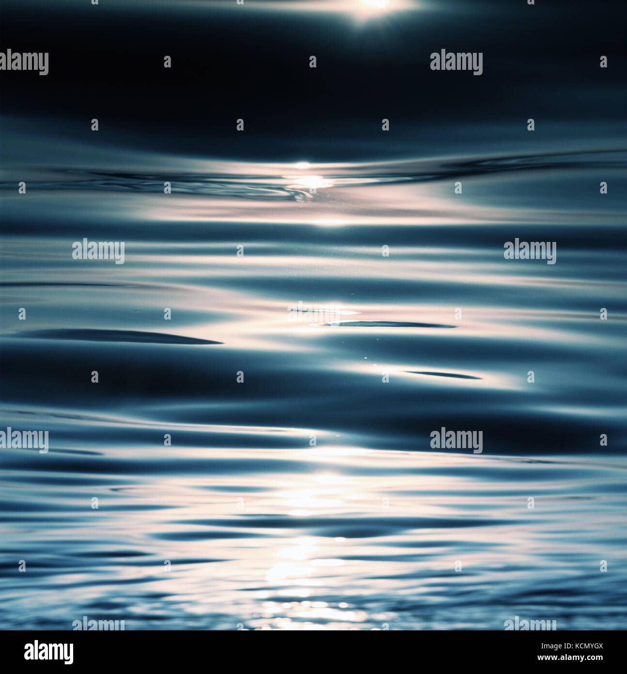 Sunshine sparkling sea waves at sunset beach Stock Photo - Alamy