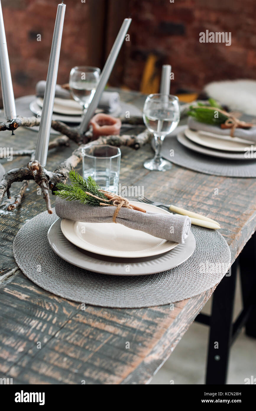 Rustic Christmas served table with vintage silverware, candles and fir ...