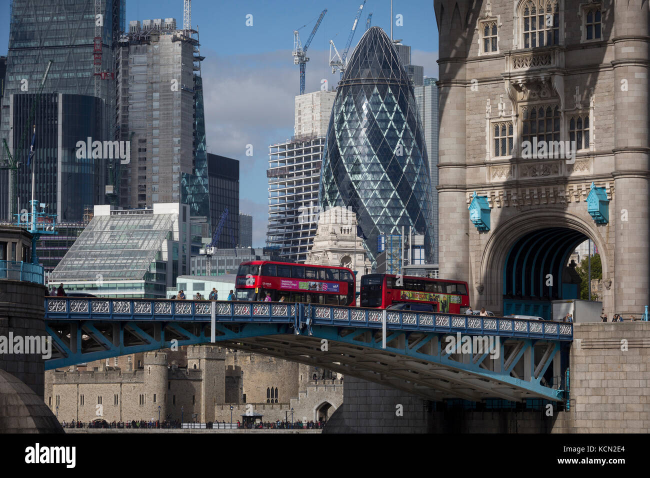Two London buses cross a cityscape of the City of London in the ...