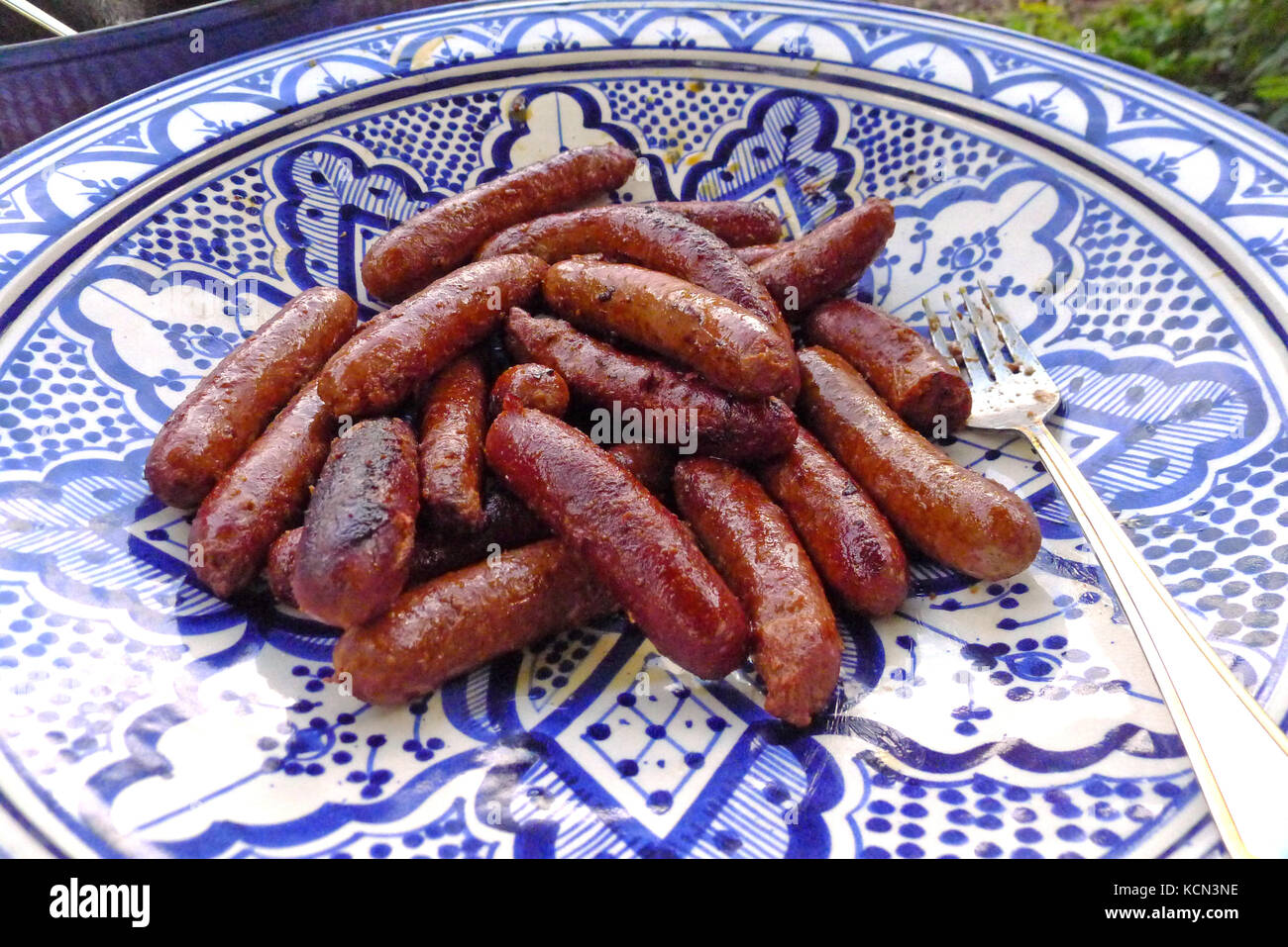 Grilled sausages on an Arabic plate in the garden Stock Photo - Alamy