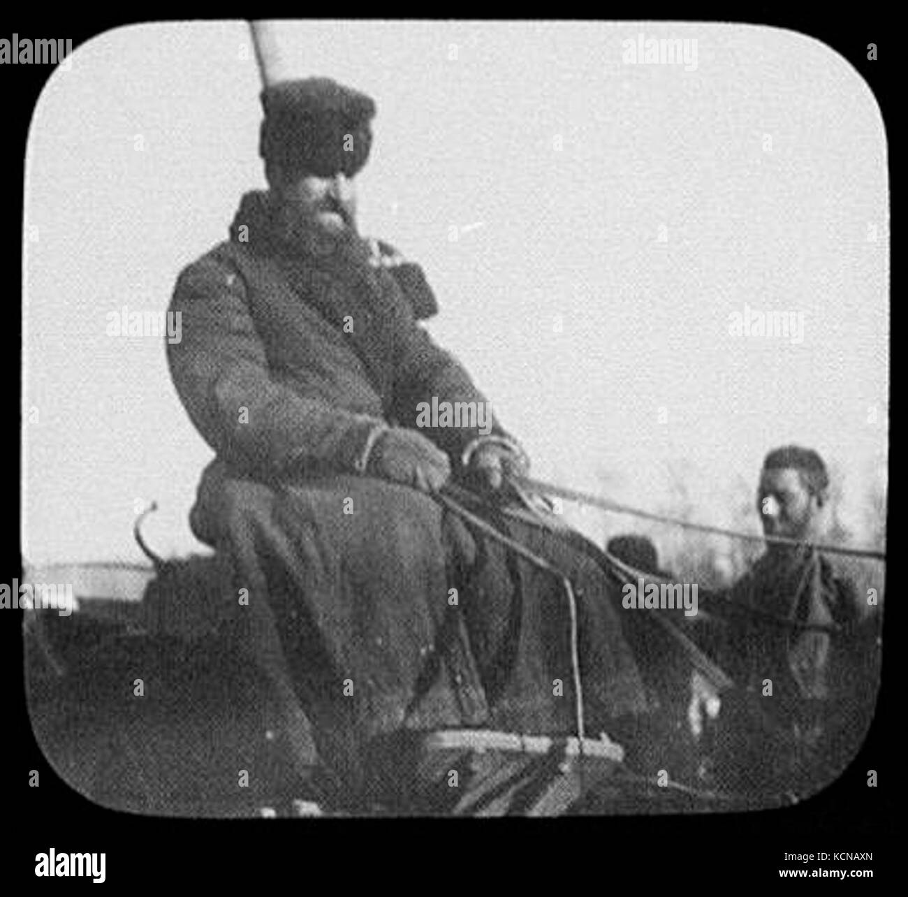 The photograph shows Colonel Tashkin holding the reins of a horse-drawn ...