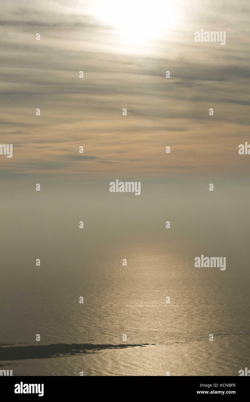 Beachy Head at sunrise in fog inversion with English channel swathed in ...