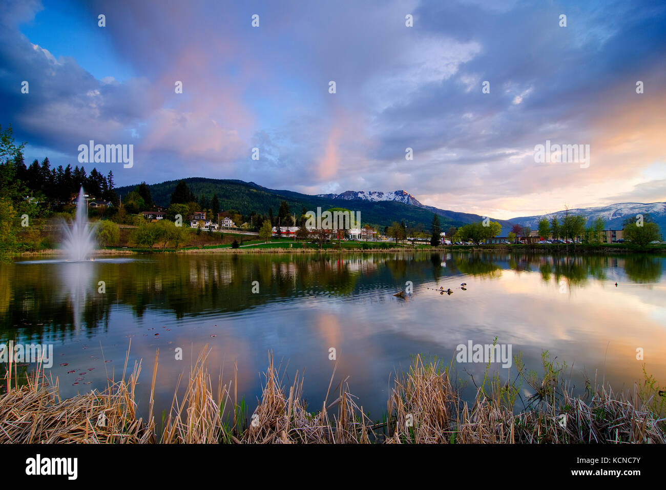 A colourful evening sky lights up Mt. Ida behind McGuire Lake in the ...
