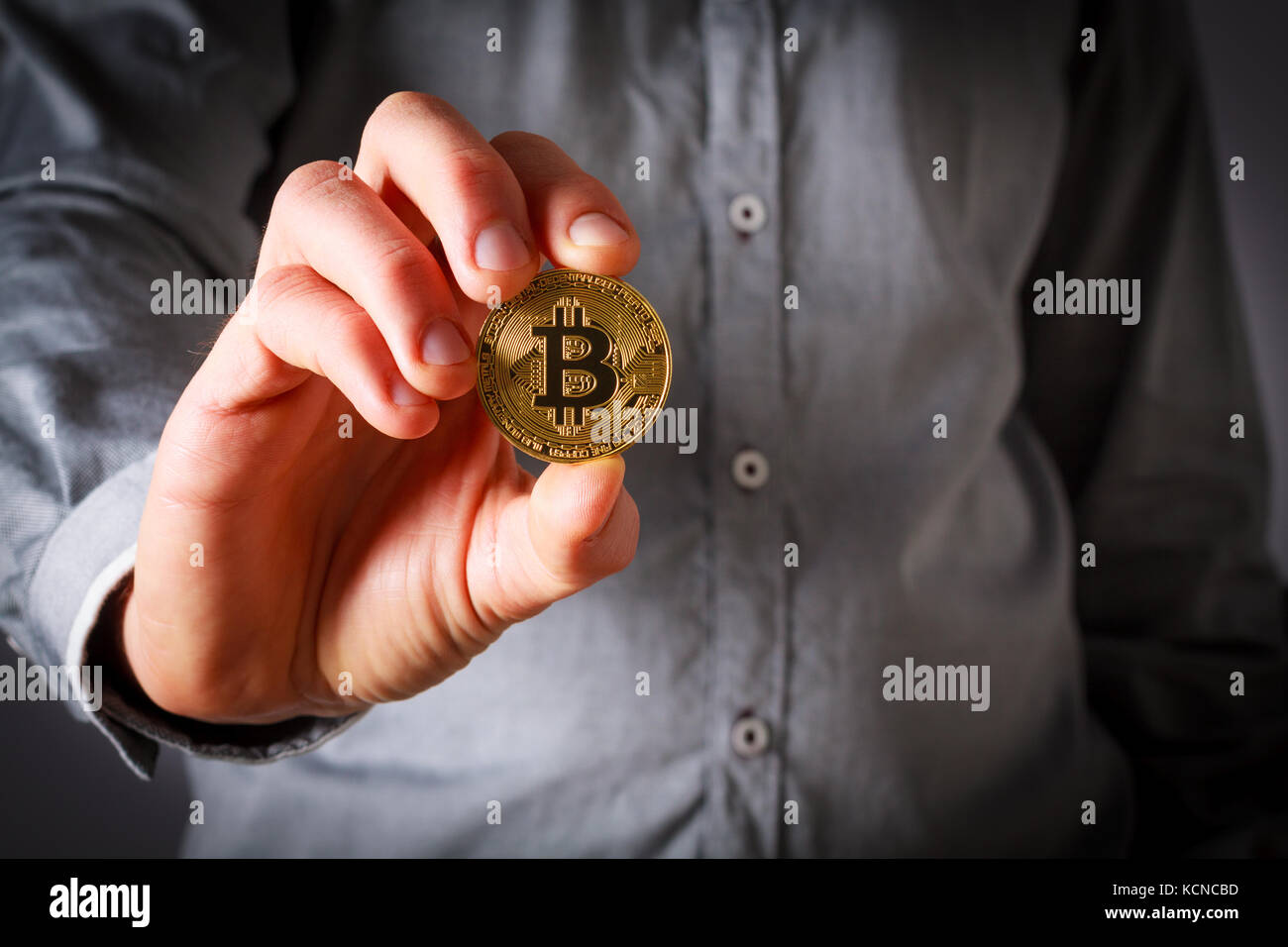 Men hold in hand the bitcoin coin Stock Photo - Alamy