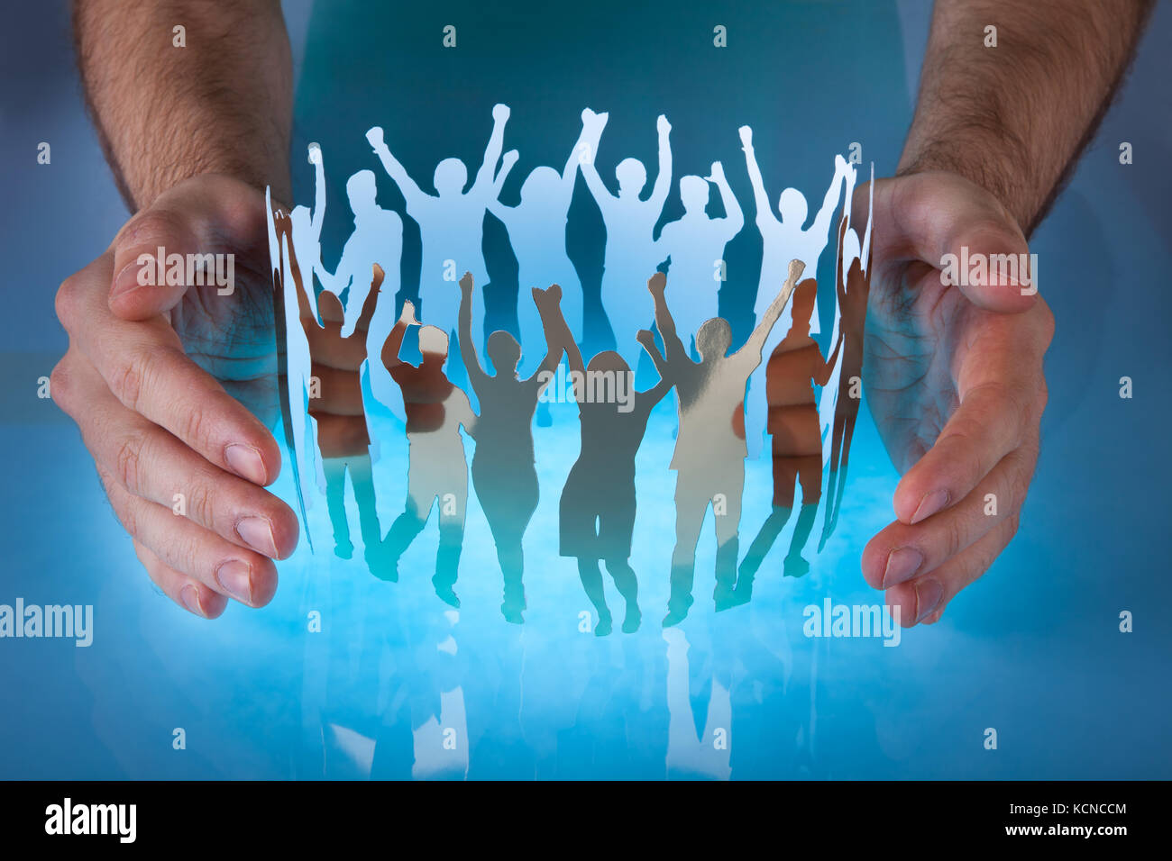 Close-up Of Hands Taking Care Of Paper Cut Out Of Human Figure Stock ...