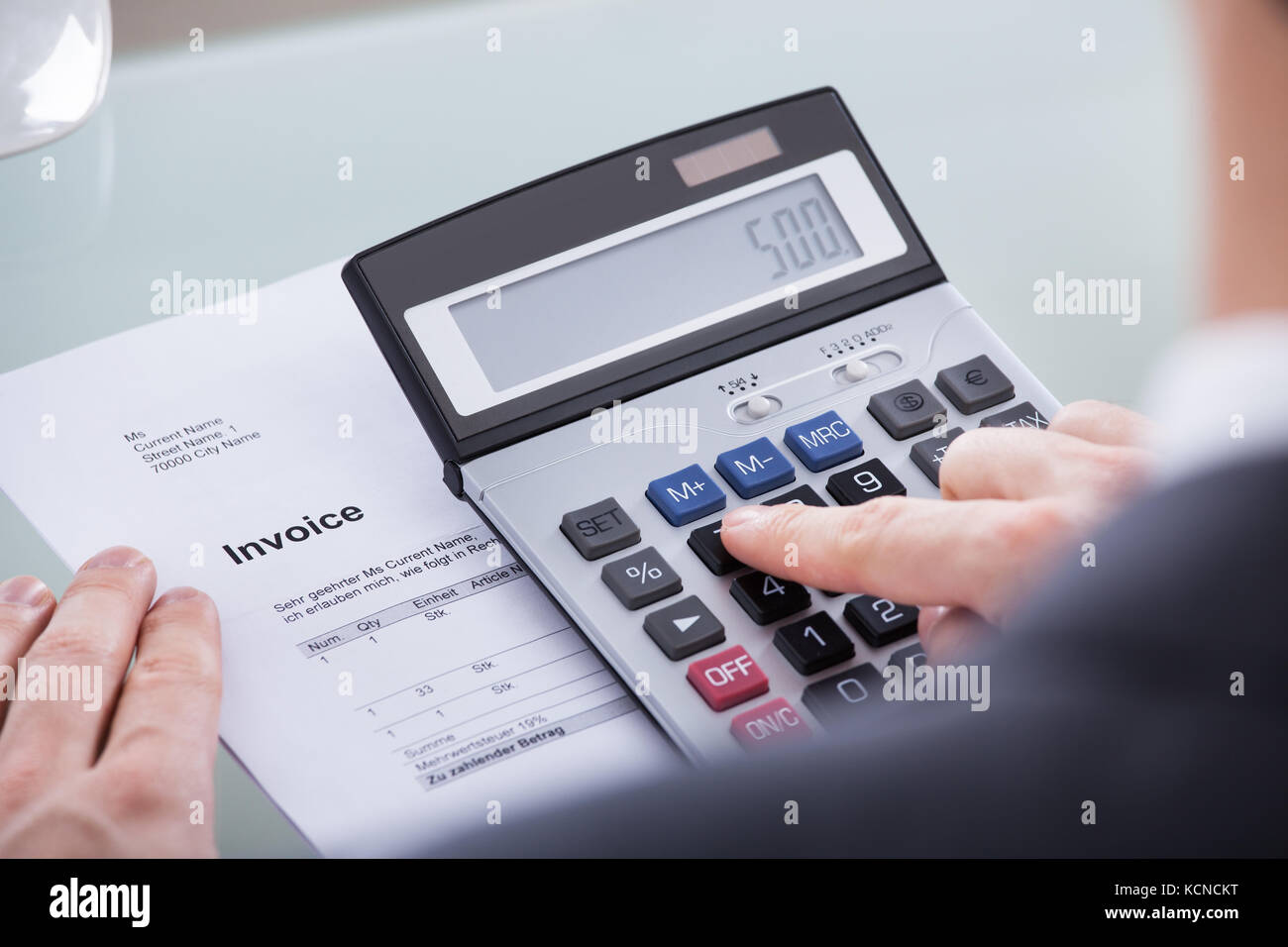 Close-up Of Businessperson Doing Calculation On Calculator With ...