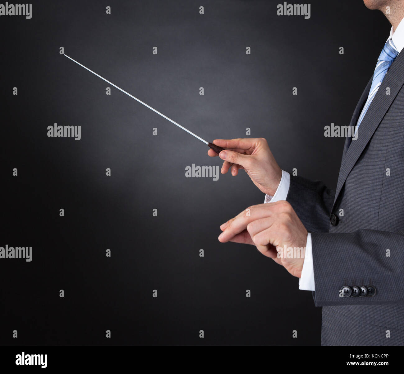 Close-up Of Orchestra Conductor Hands Holding Baton Over Black ...