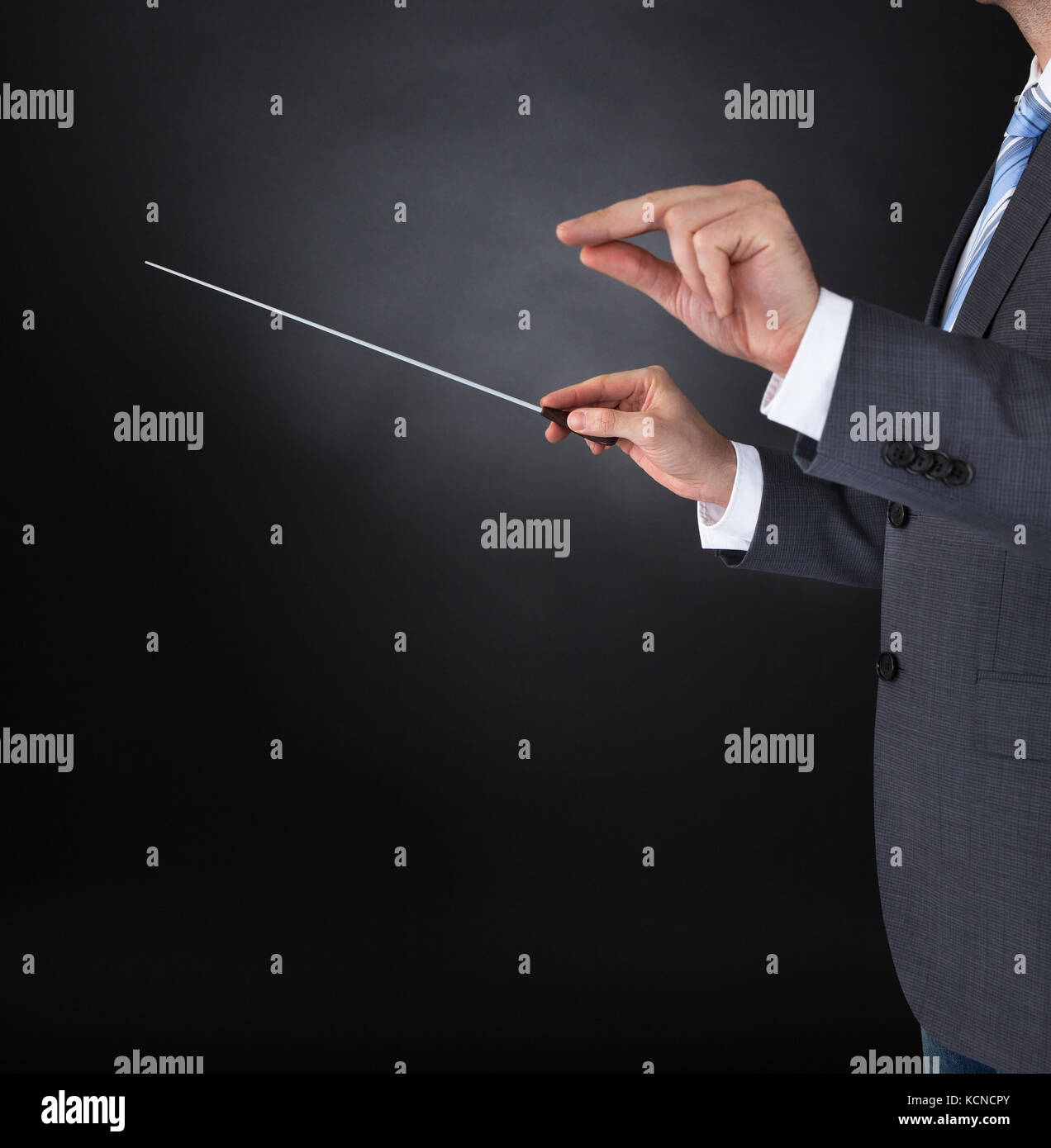 Close-up Of Orchestra Conductor Hands Holding Baton Over Black ...