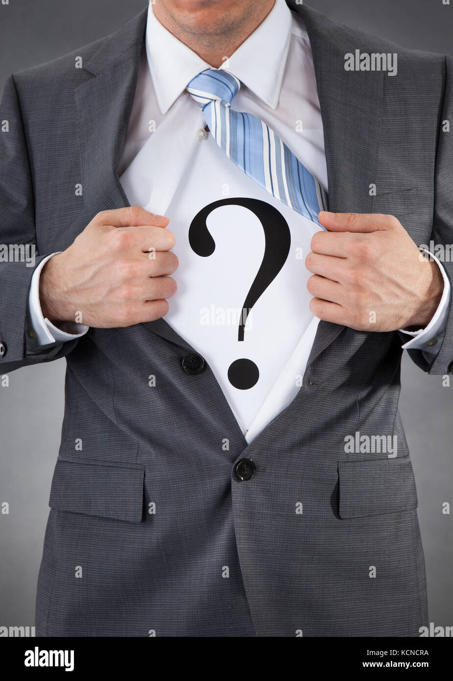 Businessman Pulling Back Shirt To Reveal Question Mark Sign Stock Photo ...