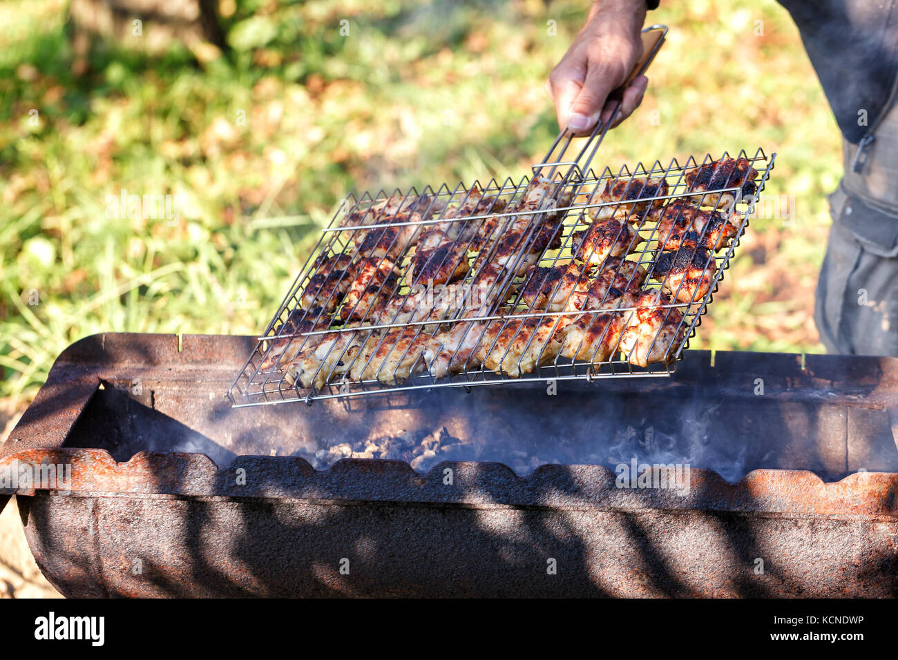 Chicken meat fried on a barbecue grill. Outdoors Stock Photo - Alamy