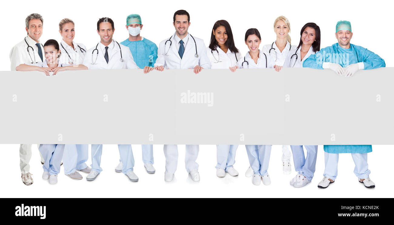 Group of doctors presenting empty banner. Isolated on white Stock Photo ...