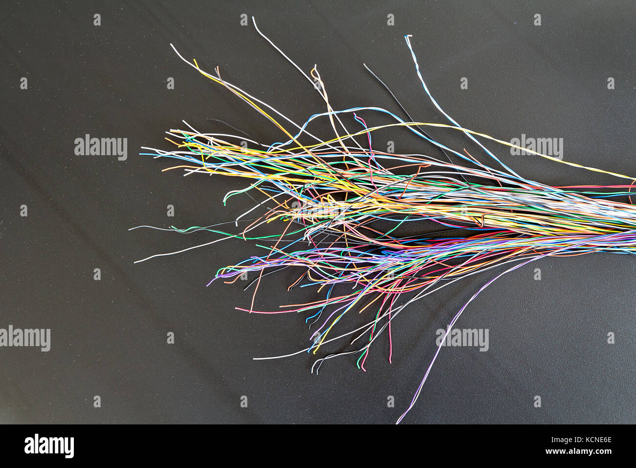 Multi color electrical wires on gray board Stock Photo - Alamy