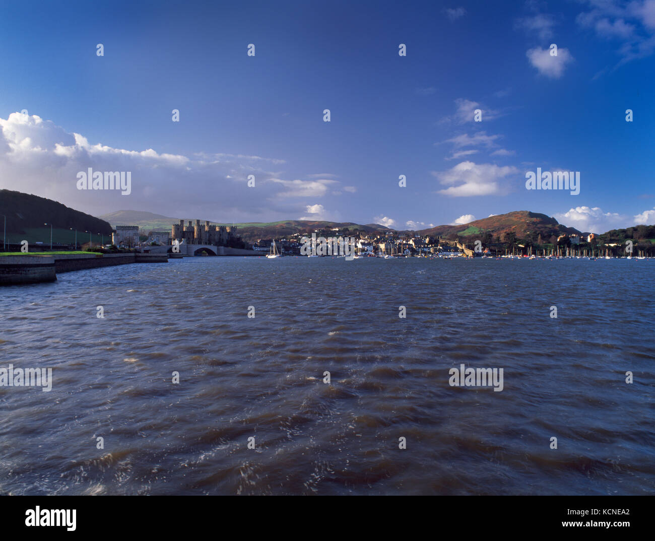 View W across the Afon Conwy estuary to Conwy Castle, bridges & walled ...