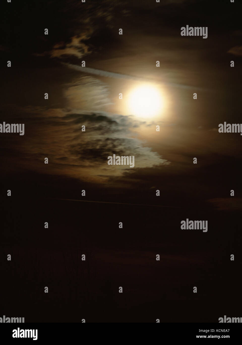 View NE of rising December full moon seen as a diffuse white patch ...