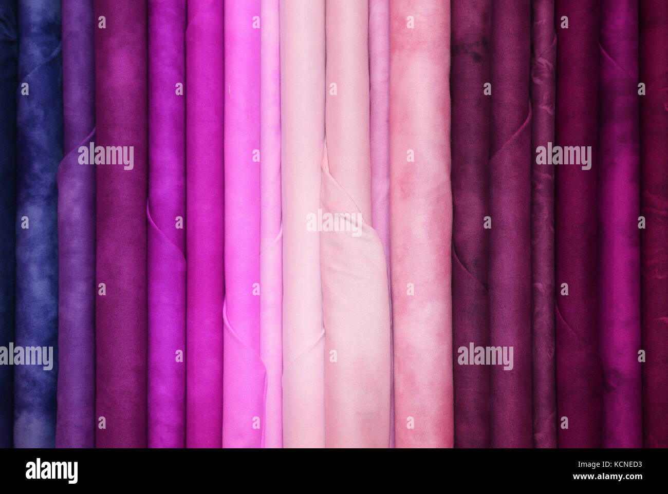 background of very colorful fabrics in the dress shop for dresses or ...