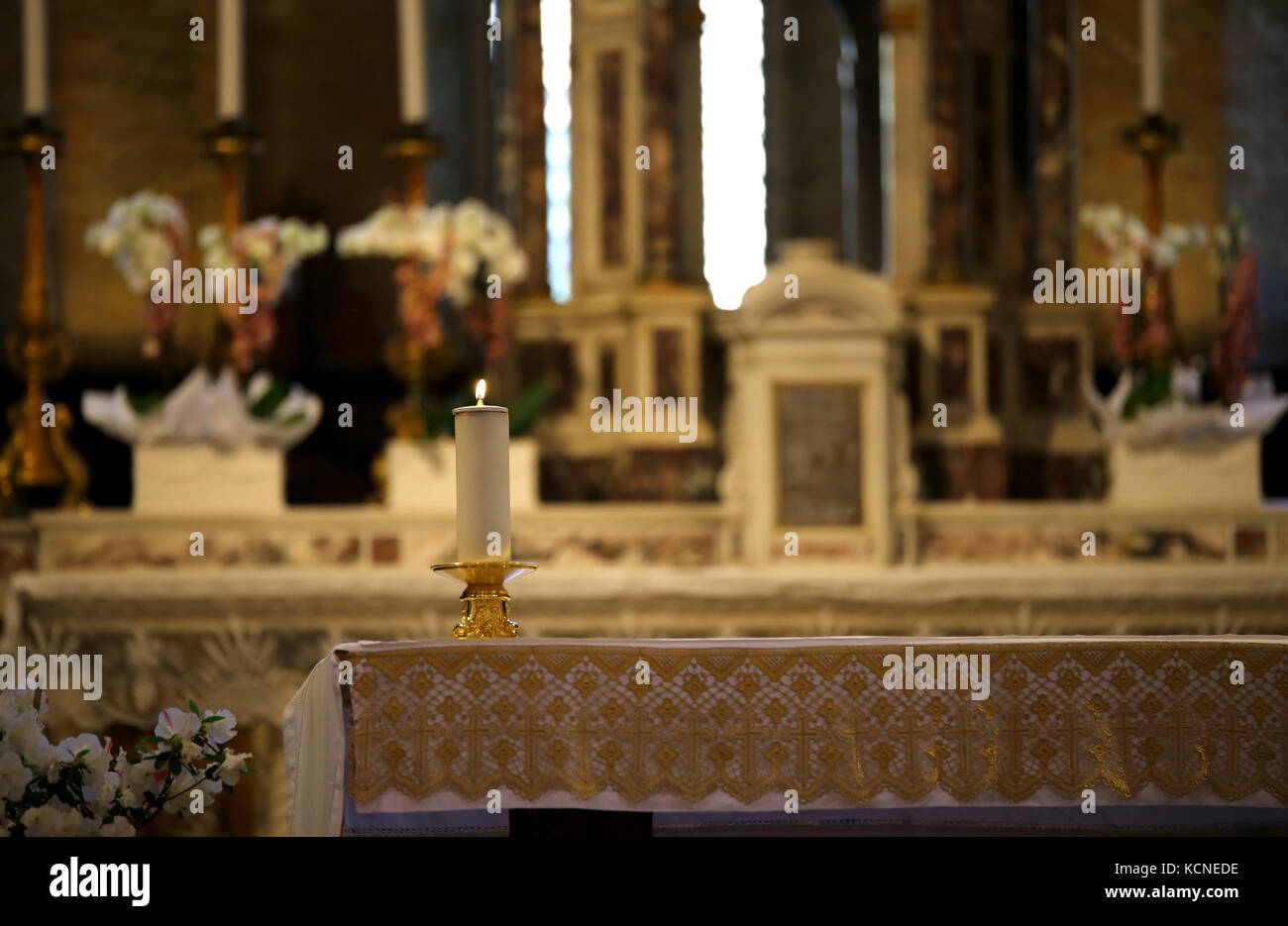 inside a church with the altar and candle lit during Holy Mass Stock ...