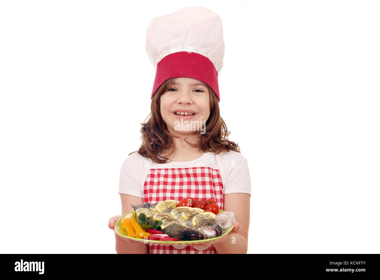 happy little girl cook with prepared trout fish on dish Stock Photo - Alamy