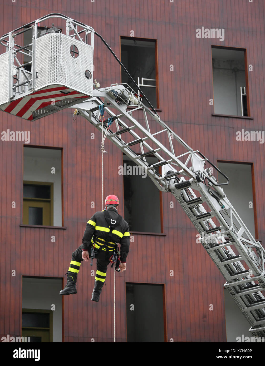 firefighter during a training exercise with the autoscale and the rope ...