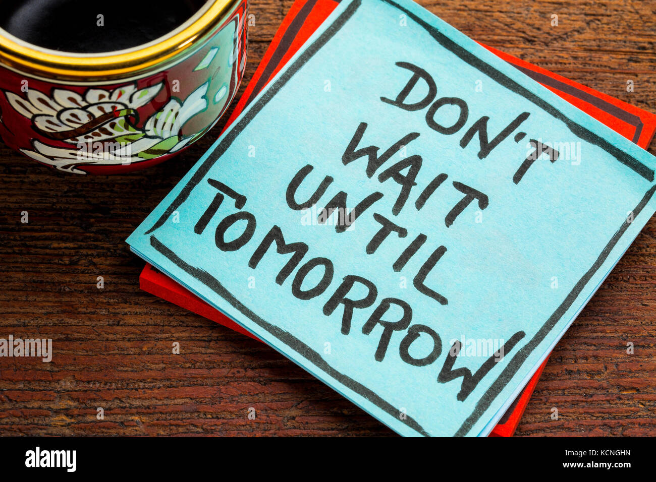 Do not wait until tomorrow - advice or reminder on a sticky note with a ...