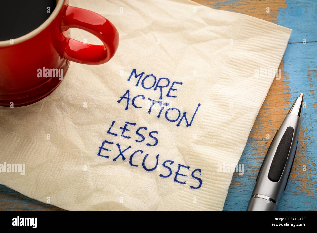 More action, less excuses - handwriting on a napkin with a cup of ...