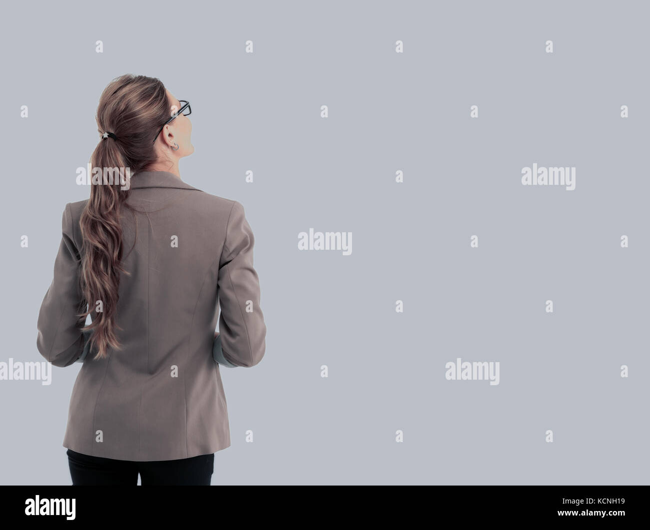 Young businesswoman looking at something. Back view Stock Photo - Alamy